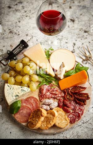 Antipasto board with various cheese and snacks. Flat lay Stock Photo ...