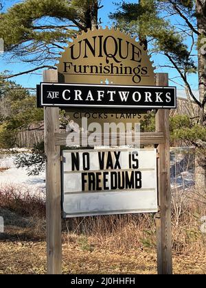 A sign reads No VAX IS FREEDUMB at Ajf Craftworks in Belgrade, Maine on ...