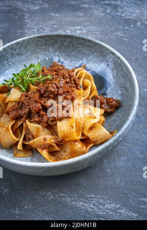 spaghetti al ragu alla Bolognese topped with shredded cheese in white ...