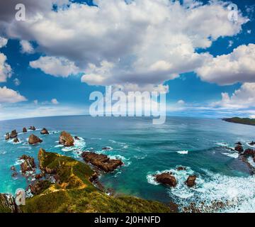 Big rocks with grass and moss at the coast of Brittany, blue sky Stock ...