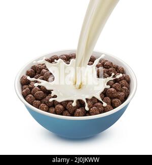 pouring milk into a chocolate corn flakes in a bowl on table Stock ...