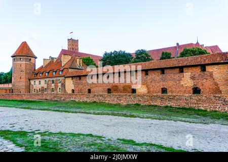 Malbork Castle in northern Poland shows red brick walls, a square keep ...