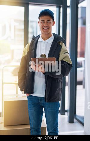 Doing his delivery rounds. Portrait of a courier unloading boxes from a ...