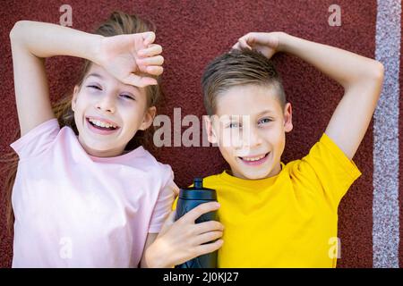 Portrait of two brothers running with their sister Stock Photo - Alamy