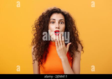 Waist-up shot of surprised and excited attractive woman holding ...