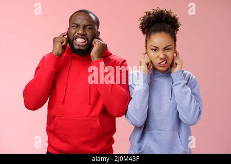 Irritated annoyed couple african american siglings man woman cringing ...