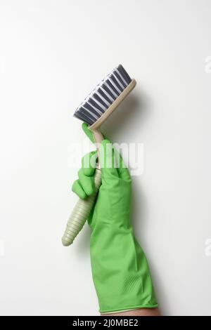 A hand in a green plastic glove holding a scalpel covered in blood ...