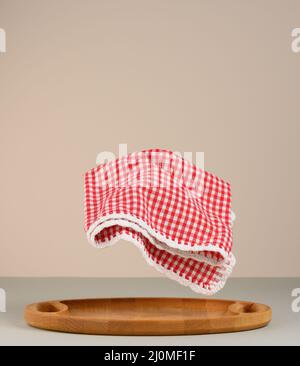 Red towel over wooden kitchen table. View from above with copy space ...