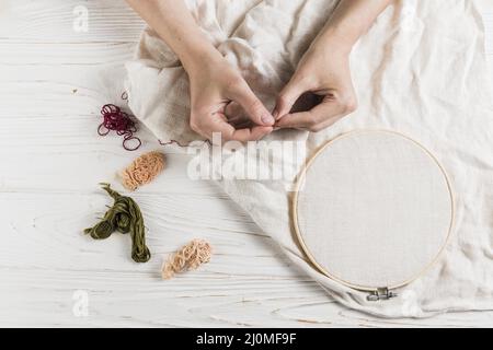 Hand holding needle thread tambour frame Stock Photo - Alamy