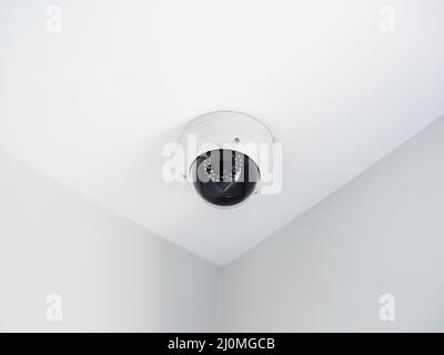 Indoor CCTV monitoring, white round security camera or surveillance ...