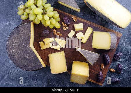 Modern style traditional aged mountain cheese of the Alps offered with ...