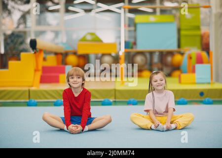 Primary school children doing gymnastics in gym class Stock Photo - Alamy