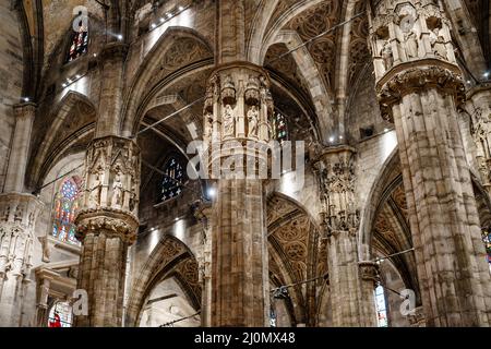 High carved columns with statues in the Duomo. Italy, Milan Stock Photo ...