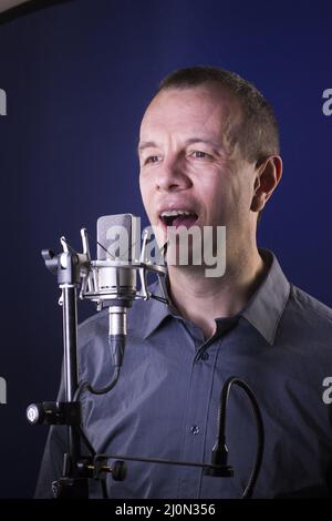 Voiceover artist actor recording voice overs in professional audio ...