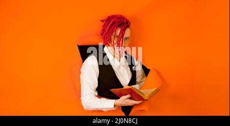 Impressive hipster in eyeglasses with red dreadlocks gamer playing ...