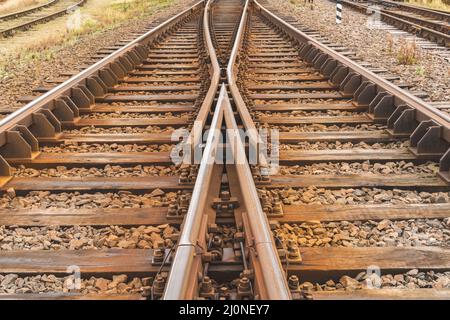 Two railway tracks merge together. Railway crossing Stock Photo - Alamy