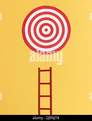 Target ladder achievement concept on pink wall studio background. Woman ...