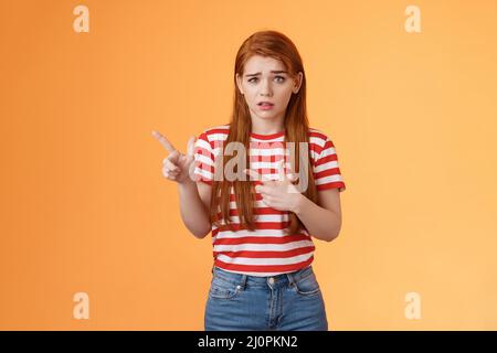 Upset gloomy redhead sad woman with red long hair asking please stop ...