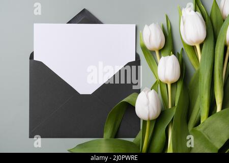 Blank invitation card mockup in craft envelope on gray concrete ...