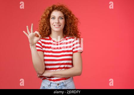 Cheerful pretty girl show okay sign and smile at camera, praise good ...