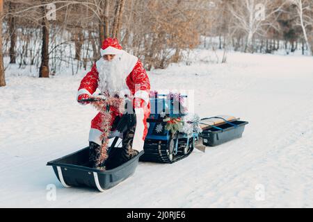 Santa claus riding snowmobile in the winter forest Stock Photo - Alamy