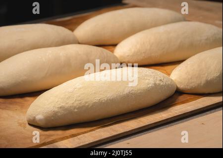 bread preparation. loaves of dough before baking Stock Photo - Alamy