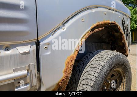 Rusty wheel arches on the car. car corrosion. Background for welding ...