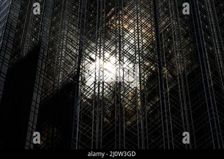 President Donald Trump is reflected in a glass table top as he speaks ...