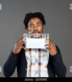 Man taking off covid-19 face mask feeling relief and satisfaction Stock ...