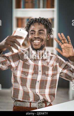 Male student having a video call with male teacher on computer at ...