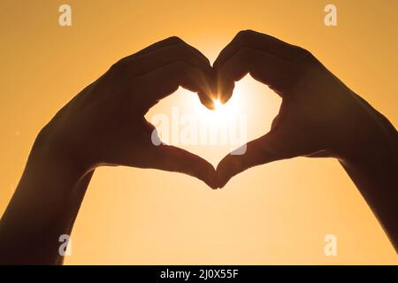 Hand shaped heart against sunset. Valentines day concept Stock Photo ...