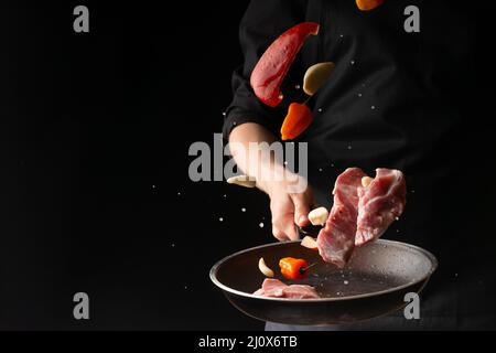Chef prepares steaks from meat, pork or beef, throwing fresh meat with ...