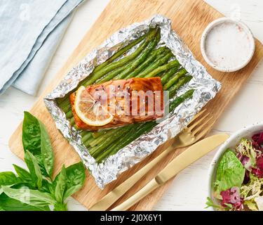 Foil pack dinner with red fish. Fillet of salmon with asparagus. Oven ...