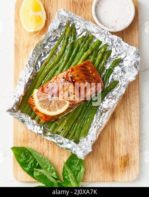 Foil pack dinner with red fish. Fillet of salmon with asparagus. Oven ...
