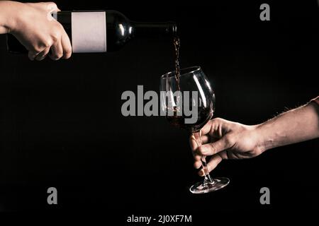 Crop hands pouring wine into glass. Beautiful photo Stock Photo - Alamy