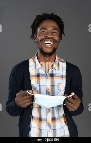 Man taking off covid-19 face mask feeling relief and satisfaction Stock ...