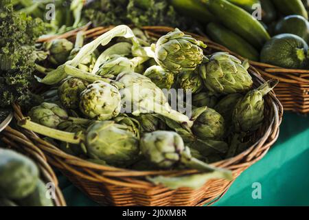 Close up artichoke pile at the market Stock Photo - Alamy