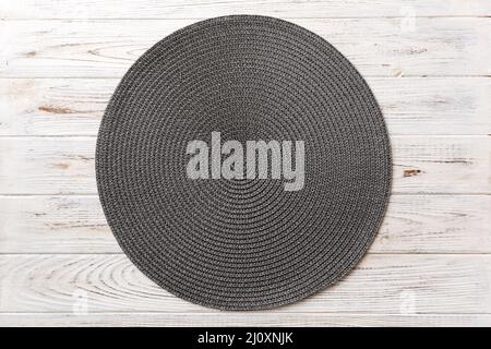 Topview of round tablecloth for food on wooden background. Empty space ...