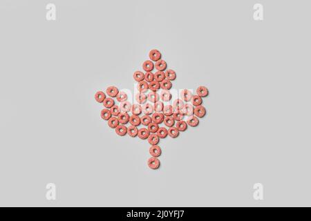 Maple leaf made of cornflakes on light background. Canadian flag ...