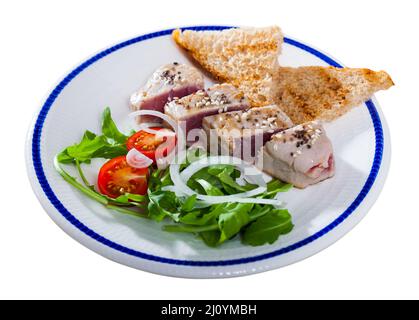 Deliciously lightly fried tuna with toasted bread, served with greens ...