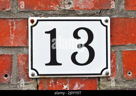 A house number plaque, showing the number thirteen (13 Stock Photo - Alamy