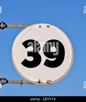 The old Number 39 sign is blue and white on the wall. The concept of ...