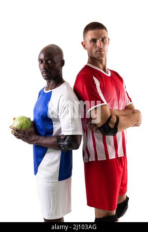 Portrait of multiracial male rival handball players standing back to ...