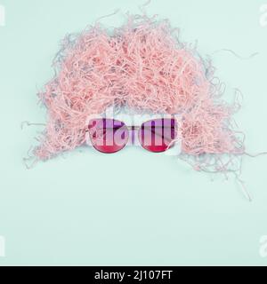 Pink shredded paper wig sunglasses mint background Stock Photo - Alamy