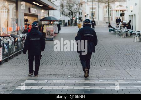 View of security guards walking down the street in the historic center ...