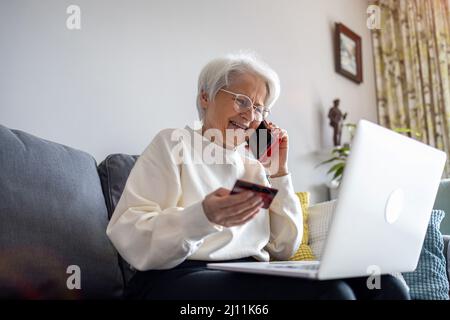 Senior woman doing online banking, paying domestic utility bills at ...