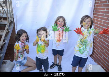 Kids playing with paint and getting stained, lot of fun Stock Photo - Alamy