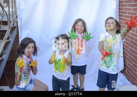 Kids playing with paint and getting stained, lot of fun Stock Photo - Alamy