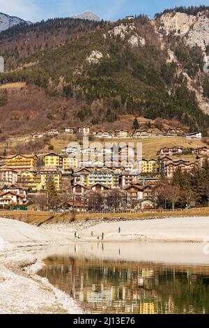 Molveno village, tourist resort, coast of the lake Molveno and mountain ...