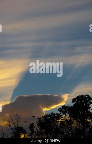 Sunset with clouds and shadows with partially clear sky, shadows cast ...